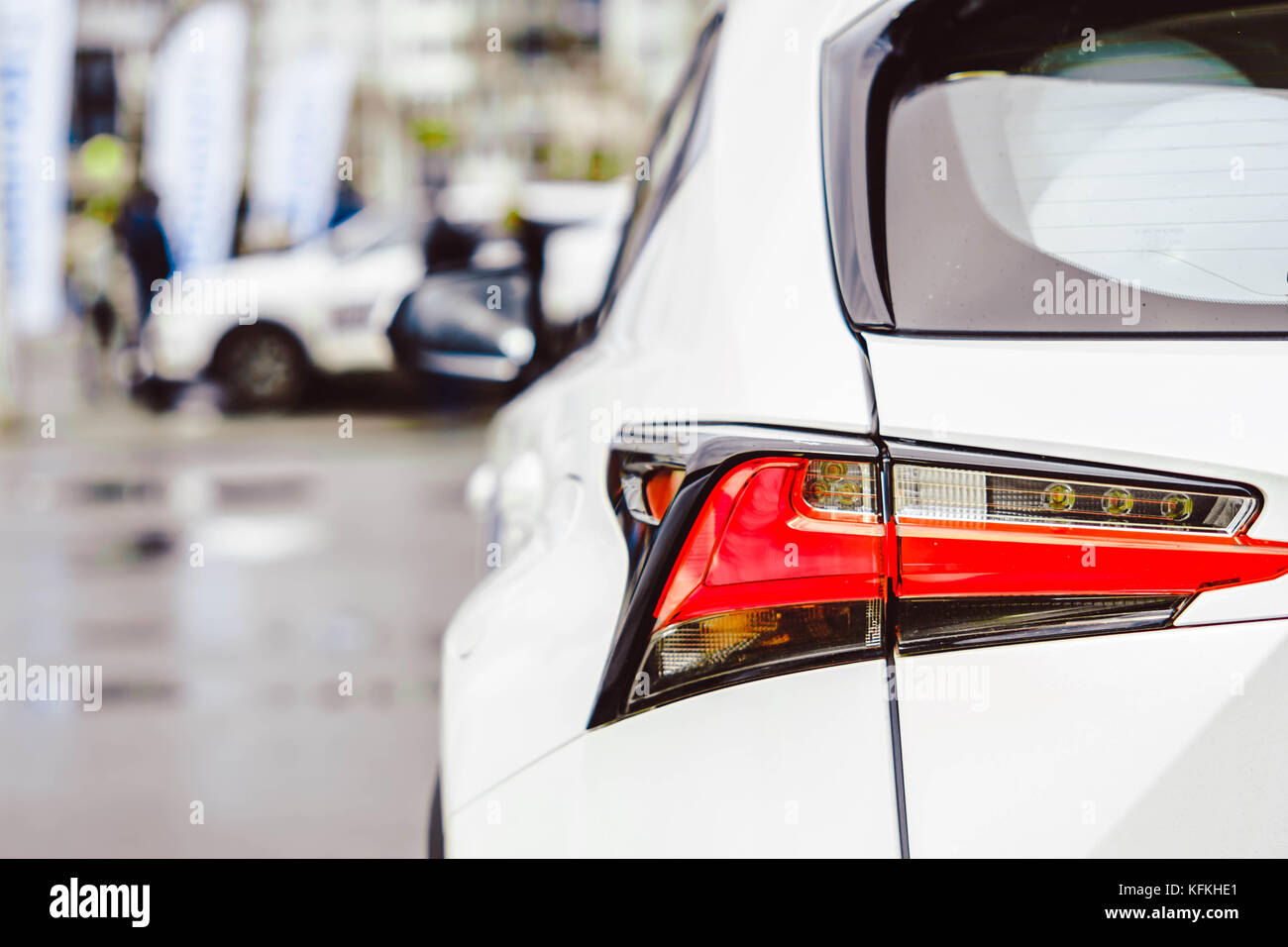 Modern blue car tail light in wet rain drop. Red modern car back light ...
