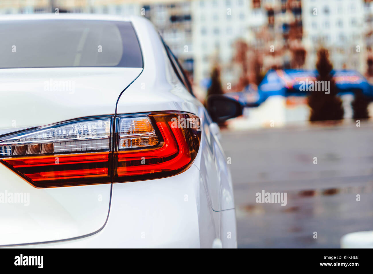 Modern blue car tail light in wet rain drop. Red modern car back light ...