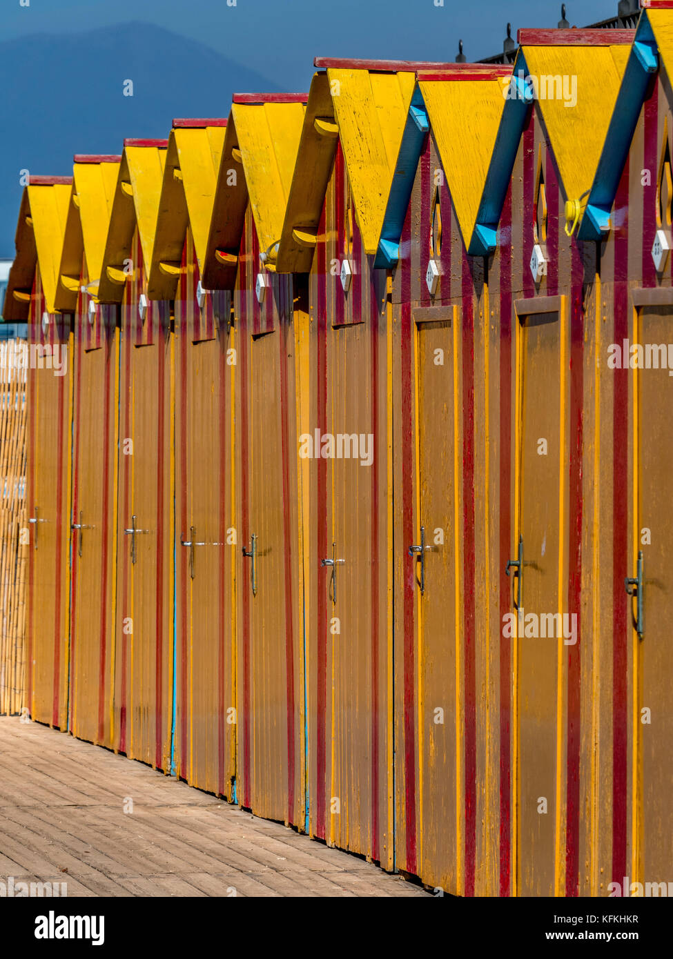 Yellow painted wooden bathing huts at Peter's Beach. A private beach in ...