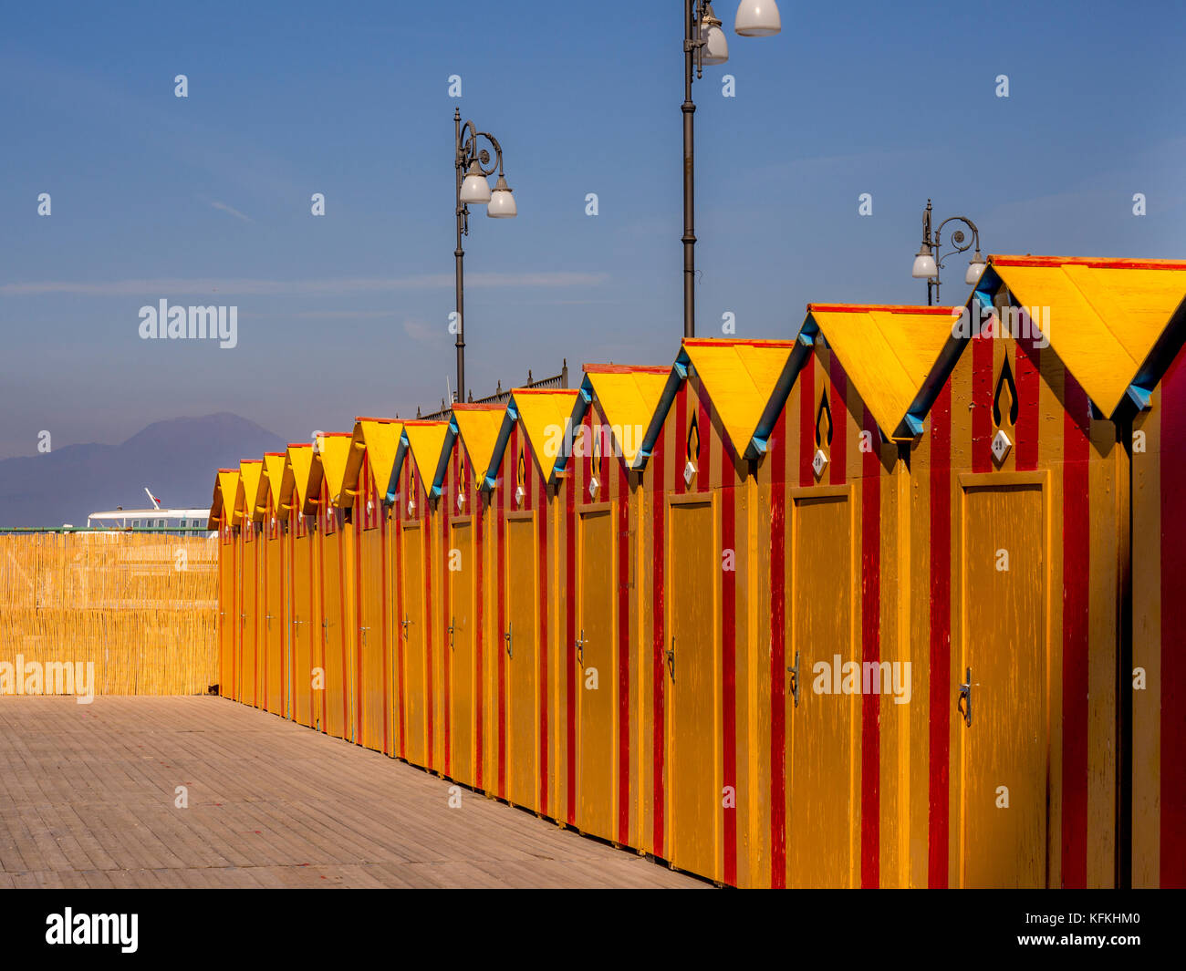 Yellow painted wooden bathing huts at Peter's Beach. A private beach in ...