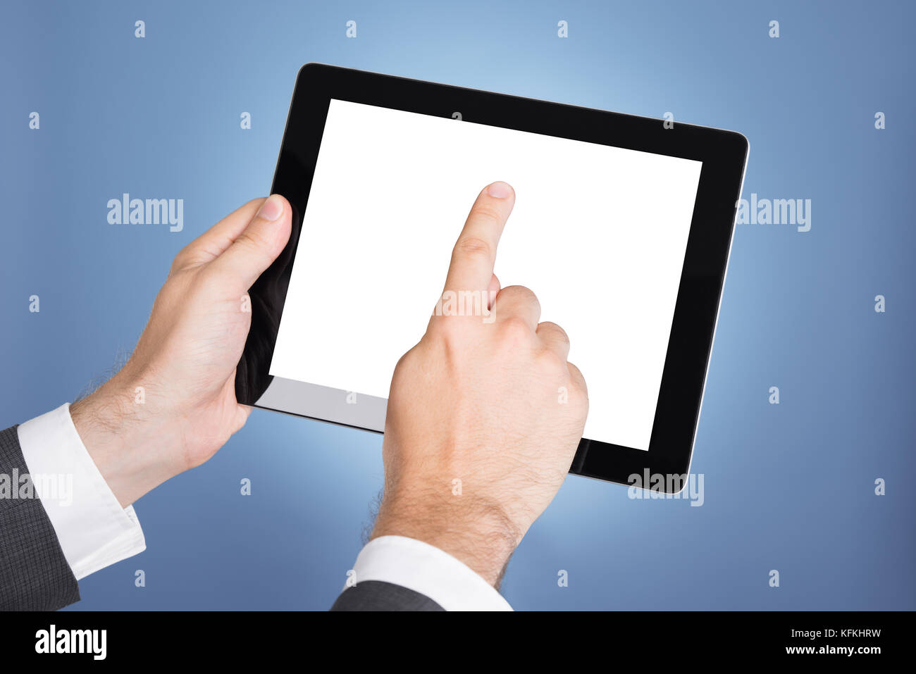 Hand pointing at tablet computer screen. Over blue background Stock ...