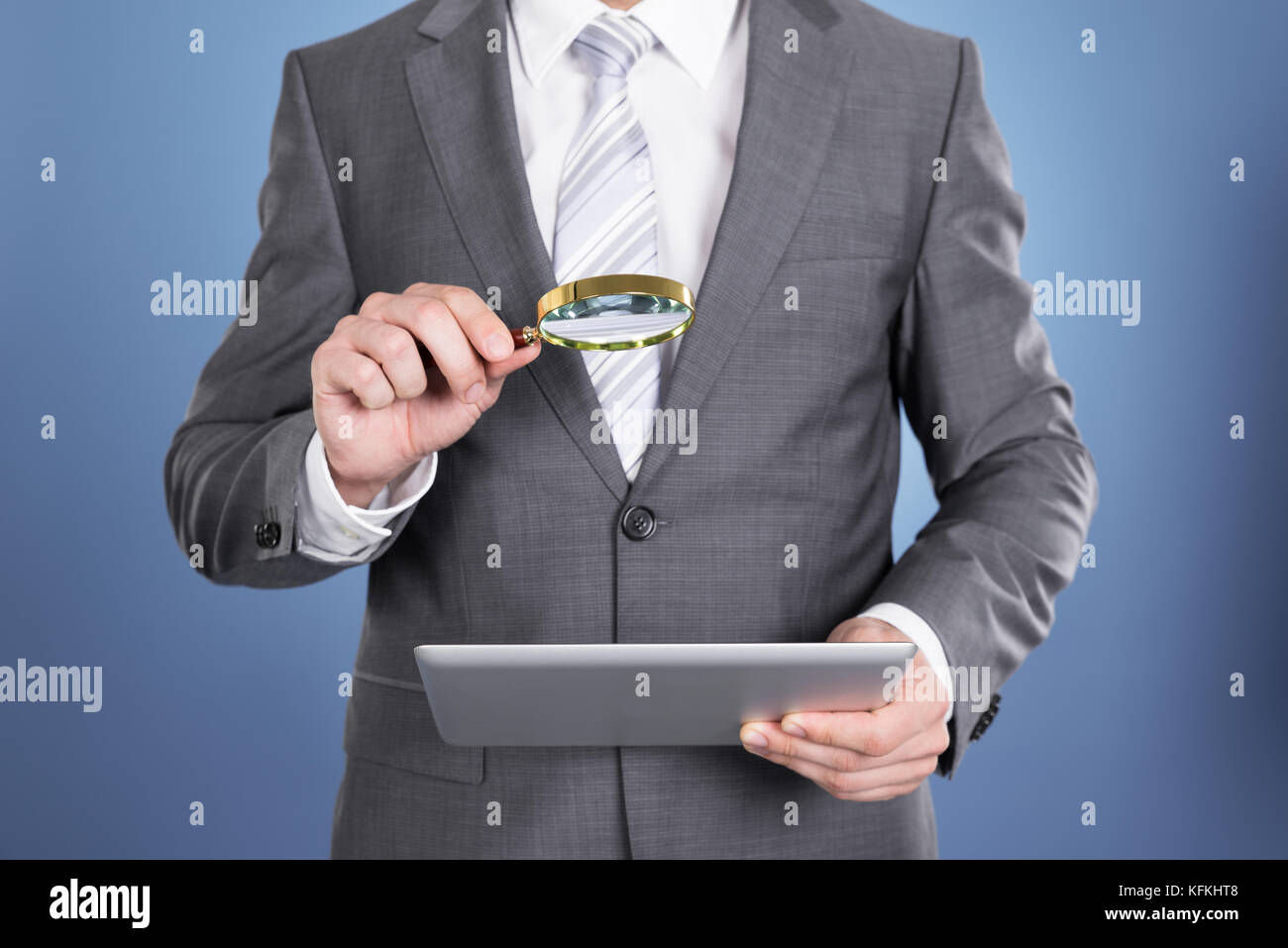 Auditor holding magnifying glass and tablet. Over blue background Stock ...