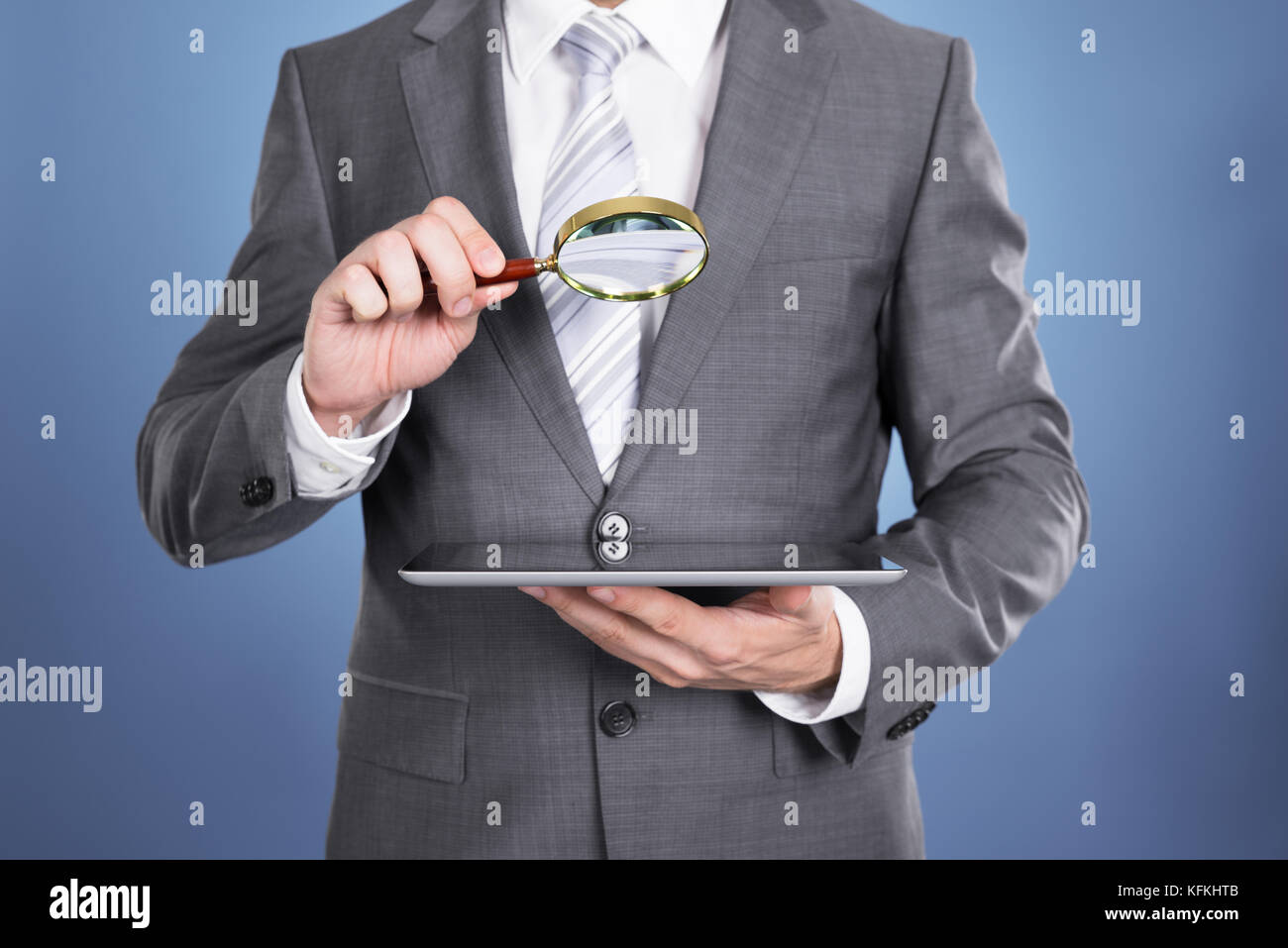 Auditor holding magnifying glass and tablet. Over blue background Stock ...