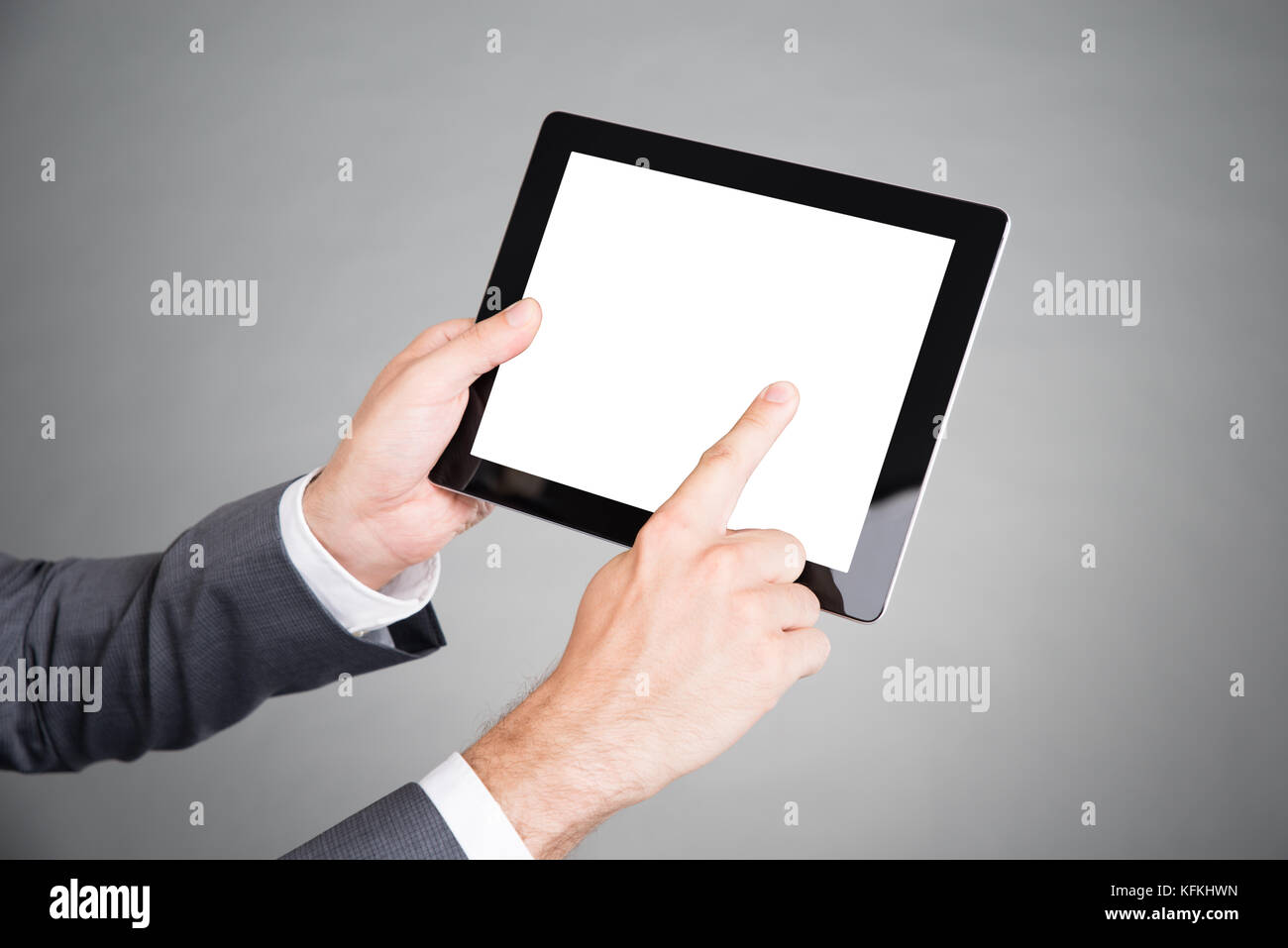 Hand pointing at tablet computer screen. Over gray background Stock ...