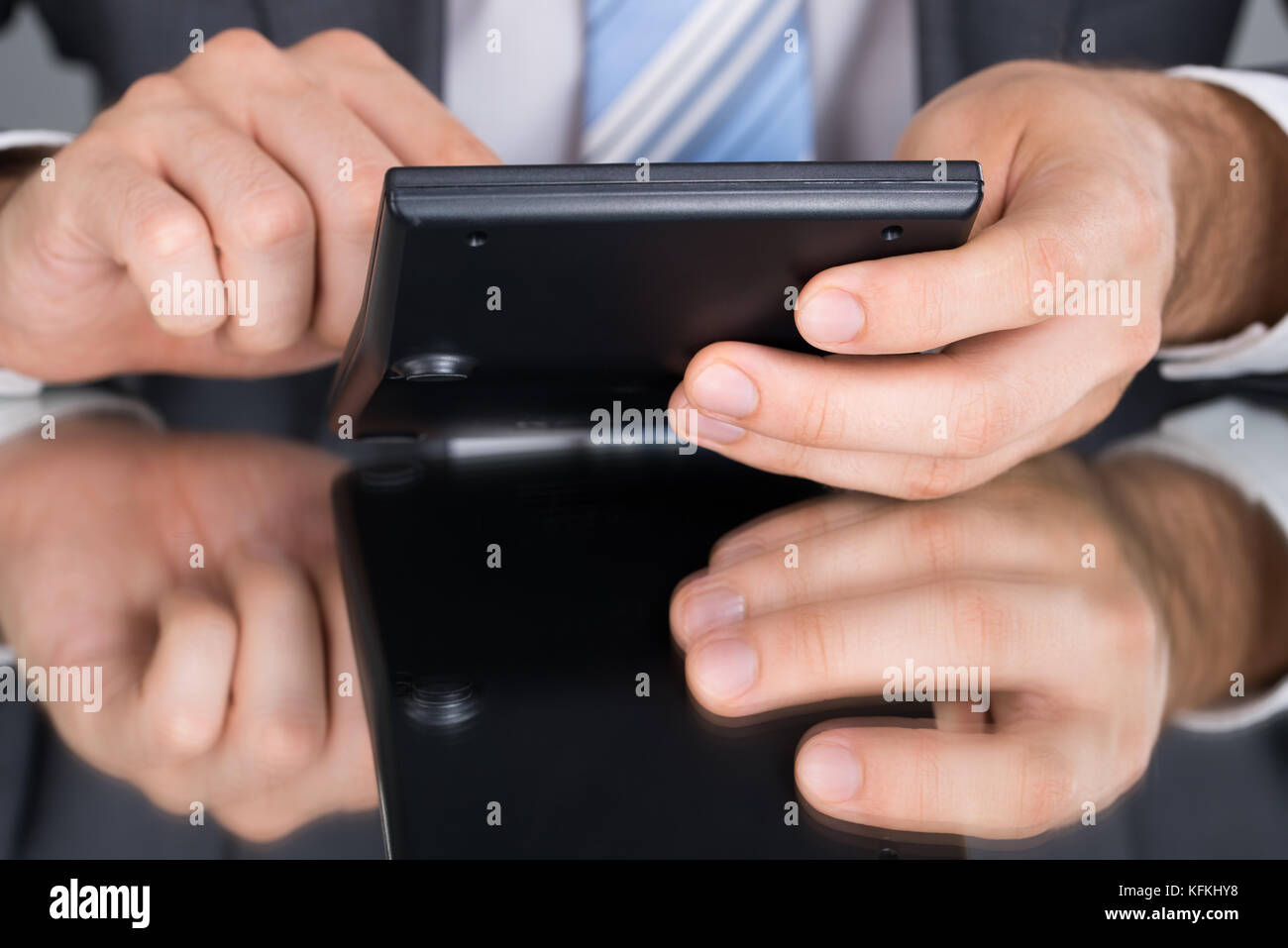 Accountant calculating tax using calculator at the table Stock Photo ...