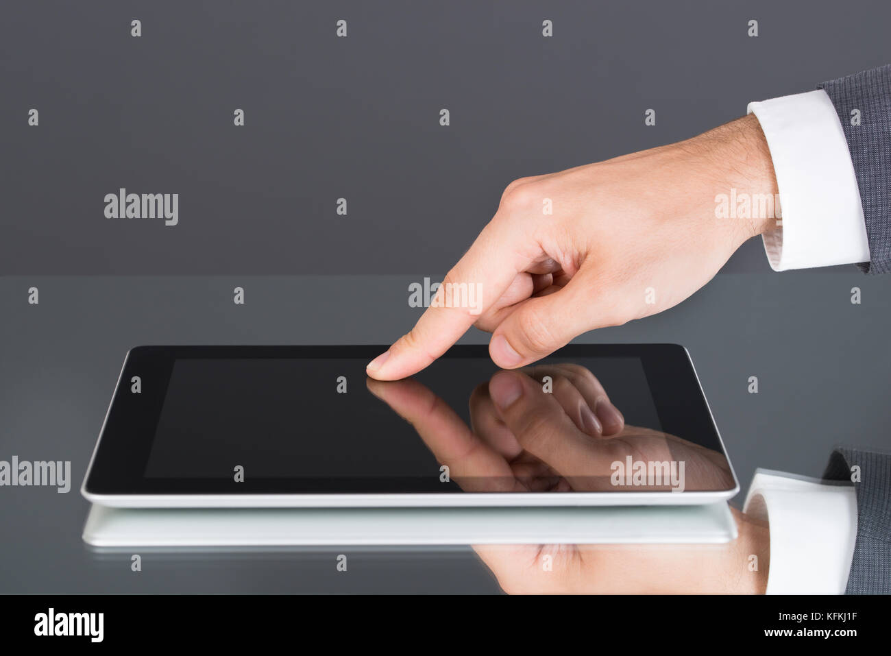 Hand pointing at tablet computer screen. Closeup shot Stock Photo - Alamy