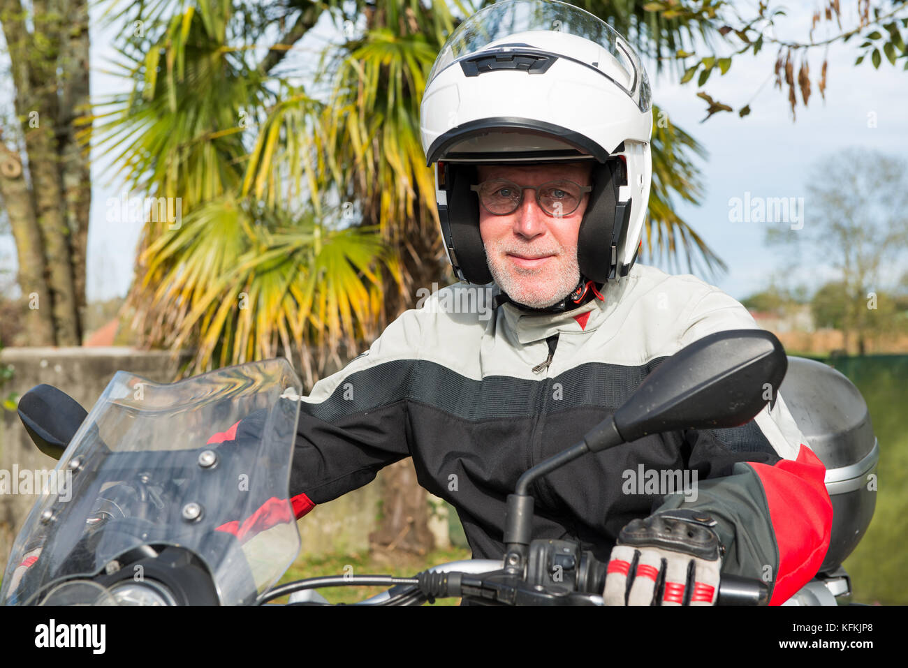 a portrait of a senior biker on his motorcycle Stock Photo - Alamy