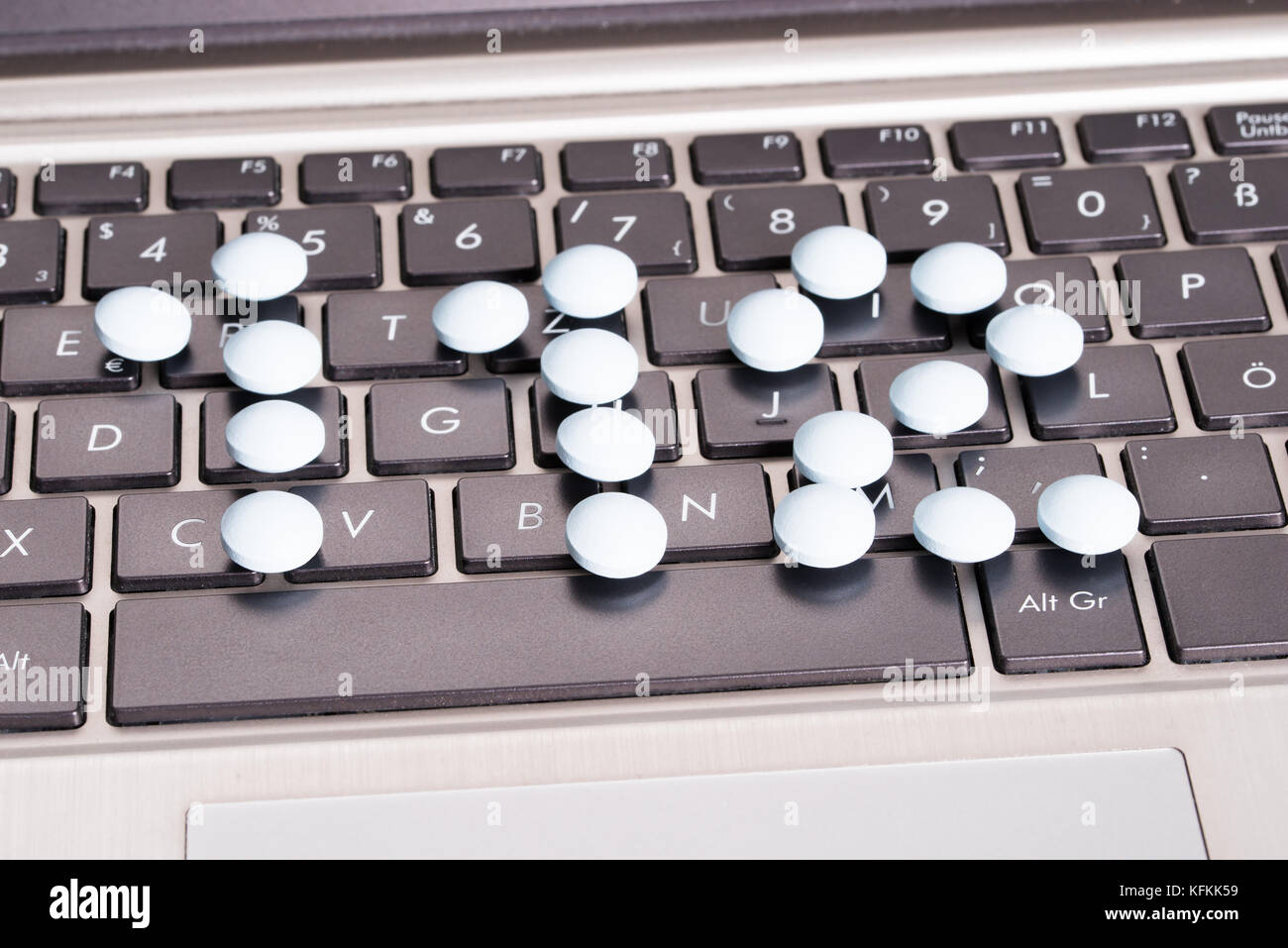 Pills on computer keyboard in online healthcare support Stock Photo - Alamy