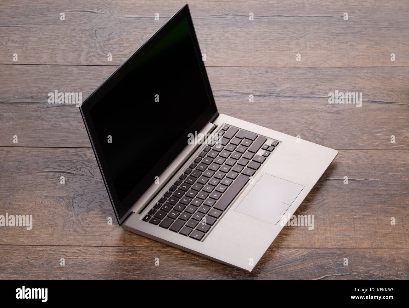 Photo of ultra portable laptop on wooden table Stock Photo - Alamy