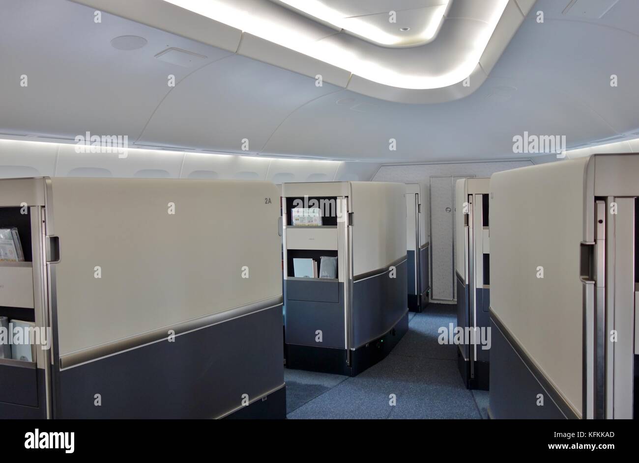View of azure blue seats and suites inside the First Class cabin of a ...