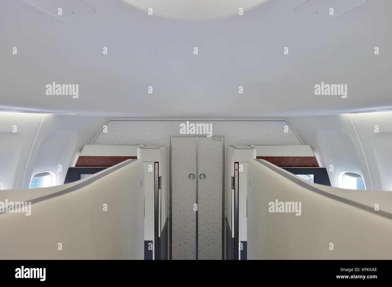 View of azure blue seats and suites inside the First Class cabin of a ...