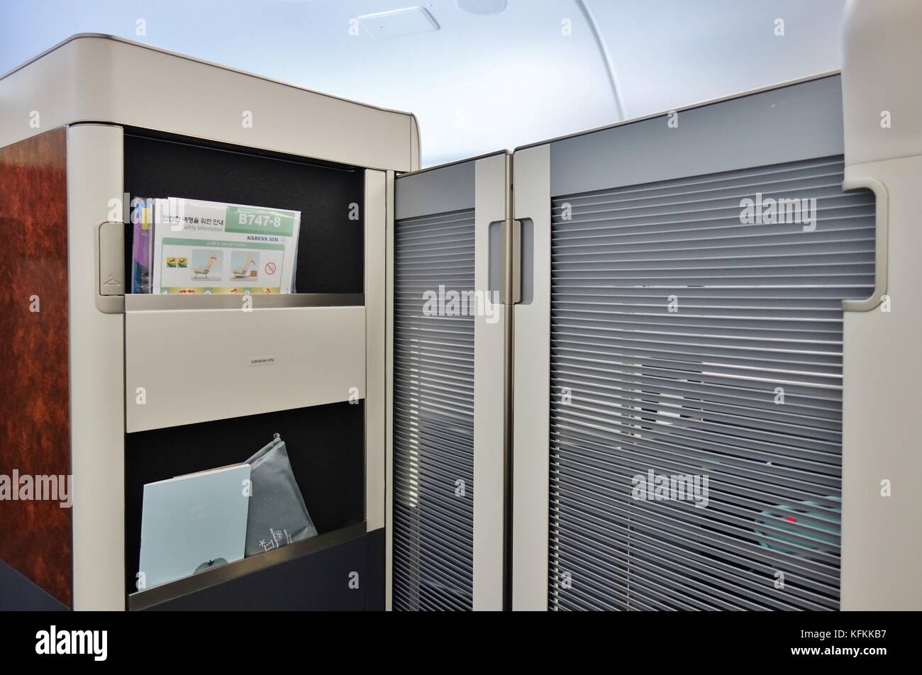 View of azure blue seats and suites inside the First Class cabin of a ...