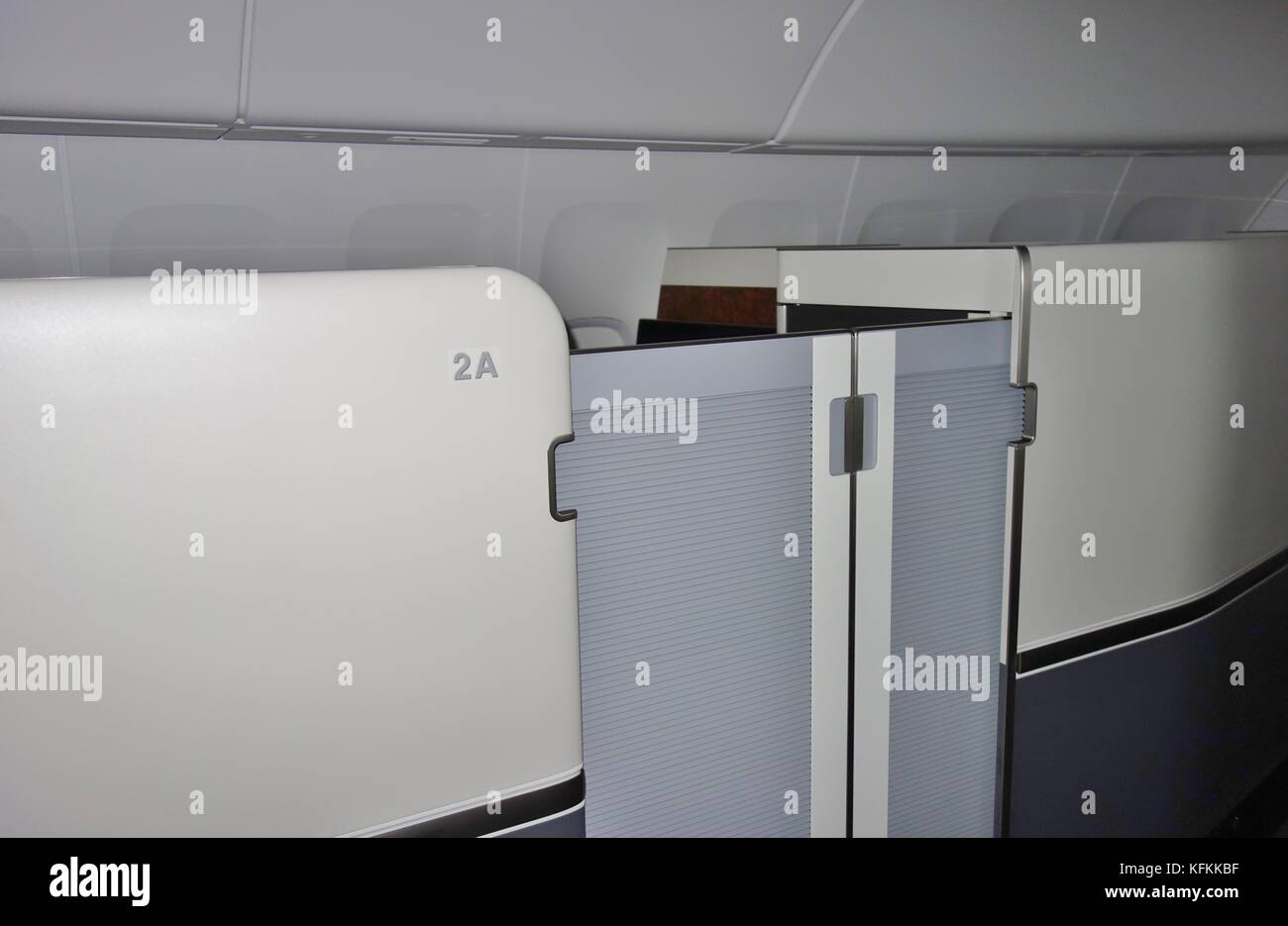 View of azure blue seats and suites inside the First Class cabin of a ...