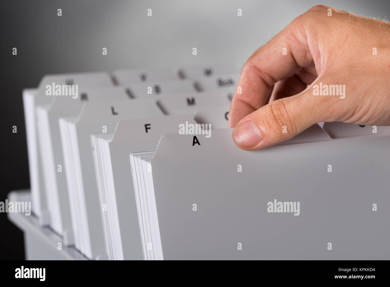 Picking file from document archive over black background Stock Photo ...