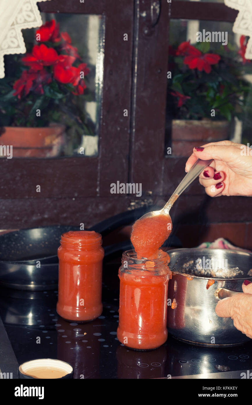 Woman making jam in kitchen hi-res stock photography and images - Alamy