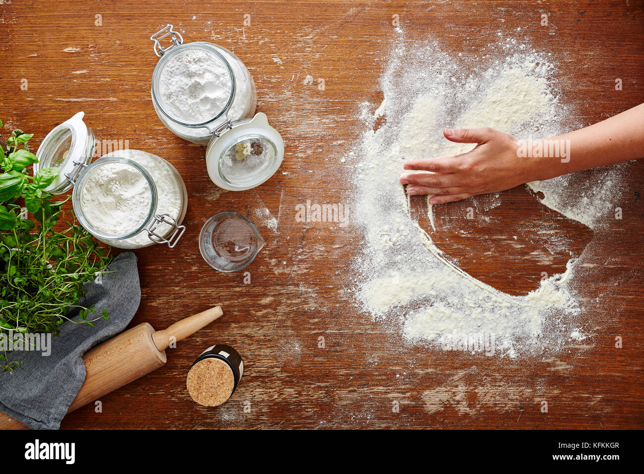 hand wiping flour on wooden table atmospheric kitchen Stock Photo - Alamy