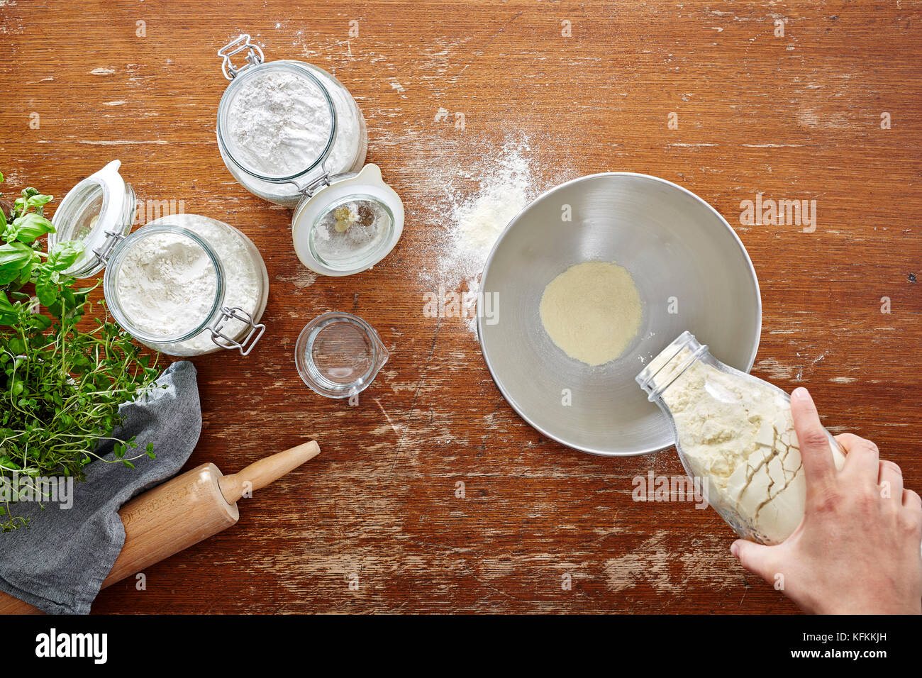 poring flour into bowl stmospheric baking scene Stock Photo - Alamy