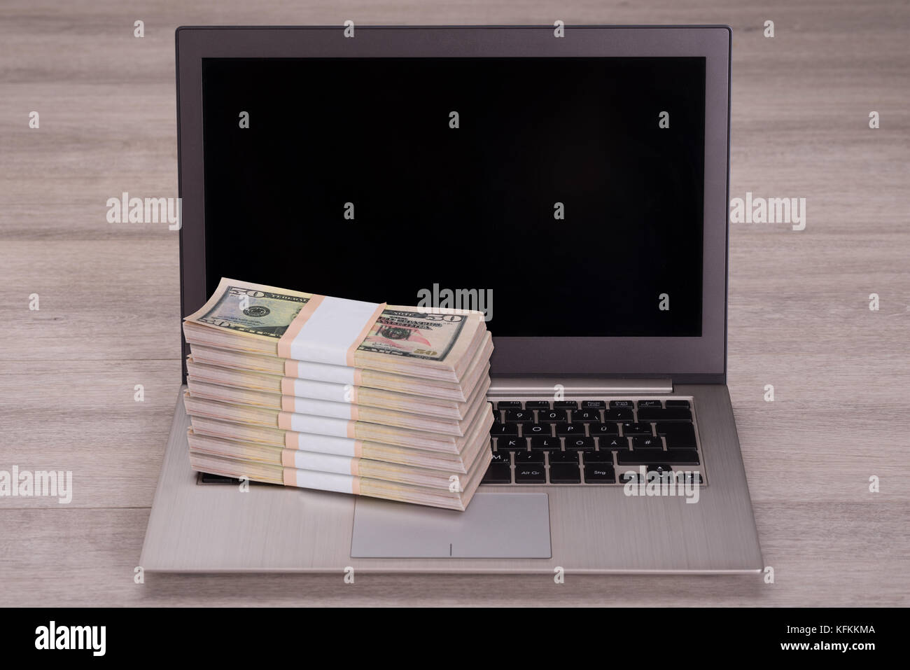 Stack of money notes on laptop keyboard Stock Photo - Alamy