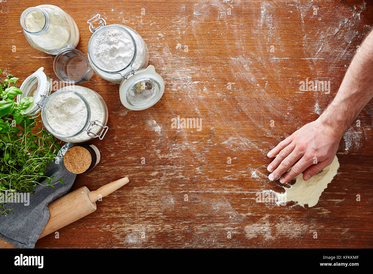 hand wiping flour on wooden workspace atmospheric kitchen scene Stock ...