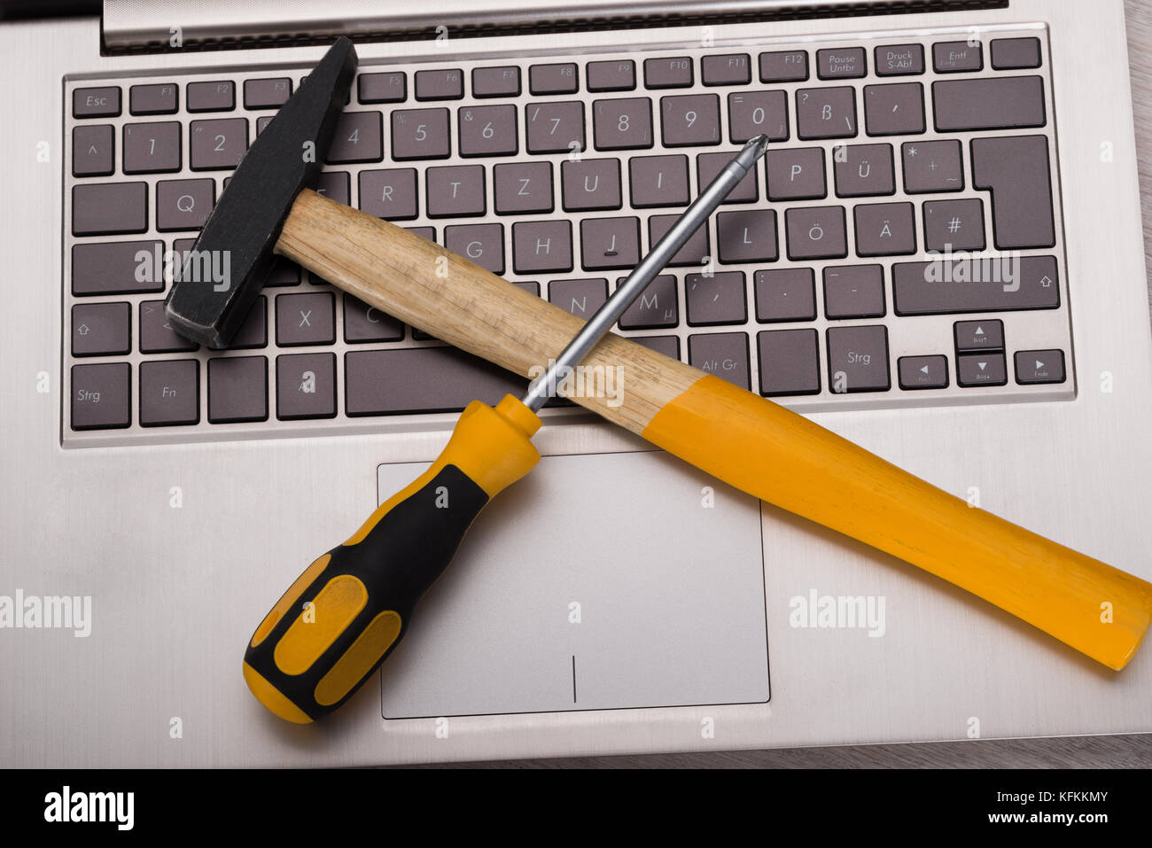 Screwdriver and hammer in computer repair concept Stock Photo - Alamy