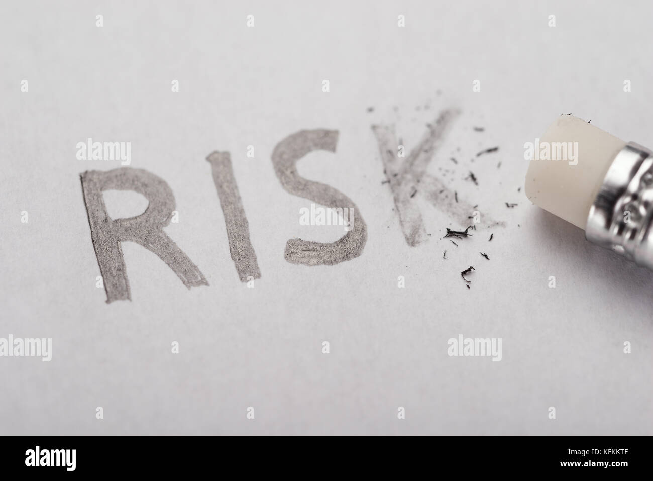 Eliminating risk pencil written word from paper Stock Photo - Alamy