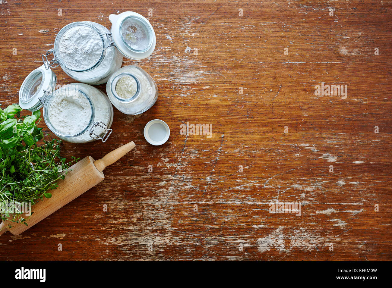 atmospheric kitchen scene with flour on wooden table Stock Photo - Alamy