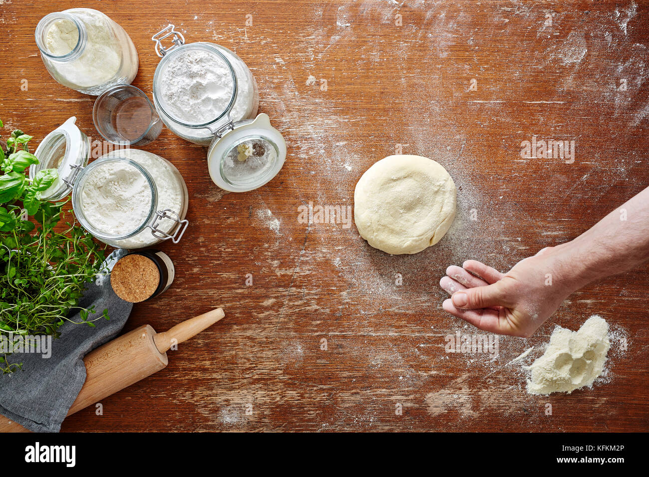 hand dusting dough with flour wooden kitchen surface Stock Photo - Alamy