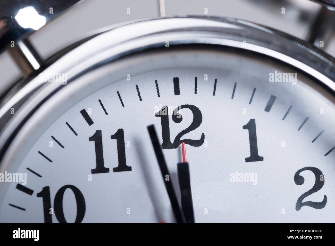 Closeup photo of alarmclock. Almost noon time Stock Photo - Alamy