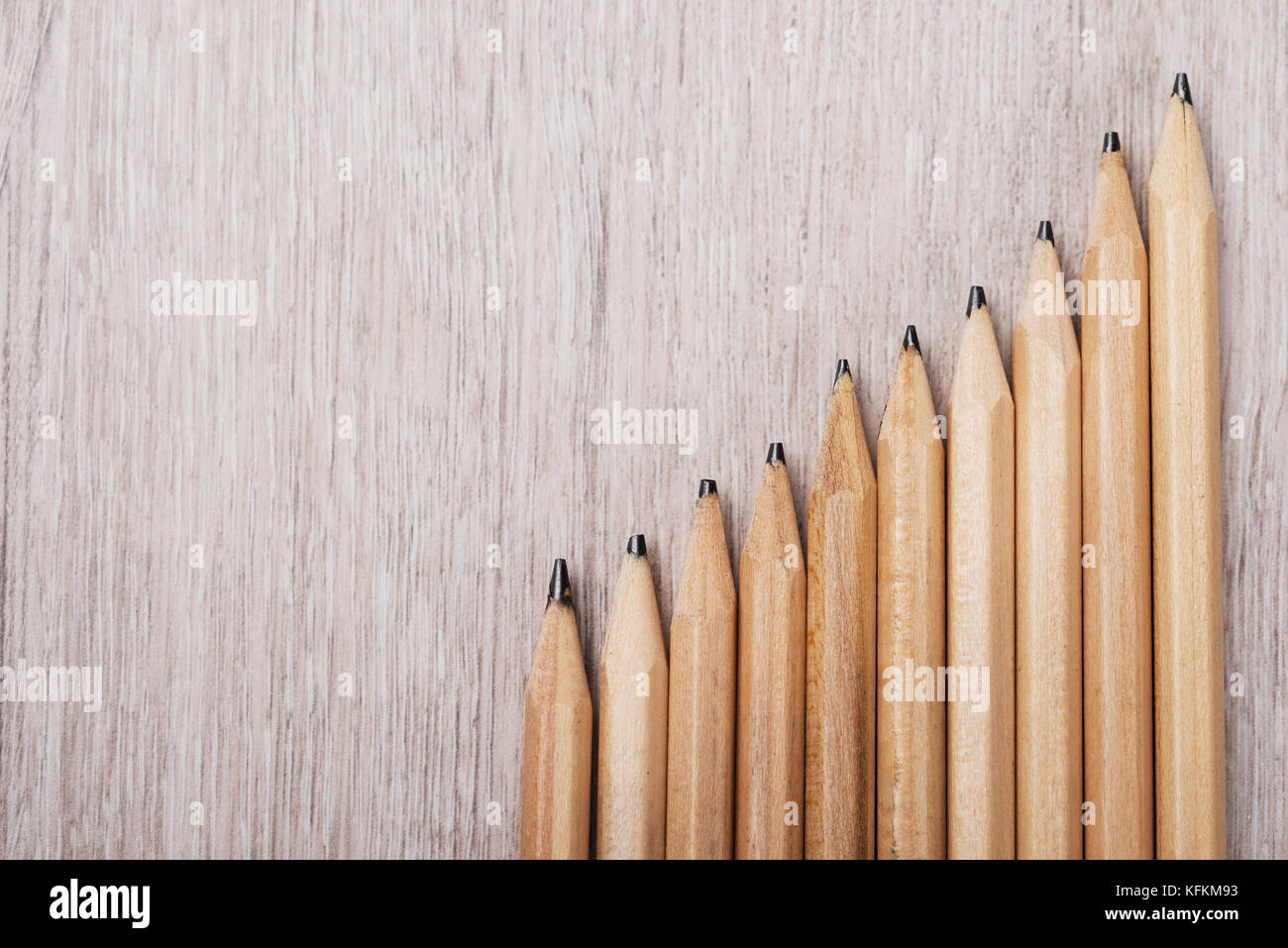 Progressive graph made from pencils on wooden table Stock Photo - Alamy