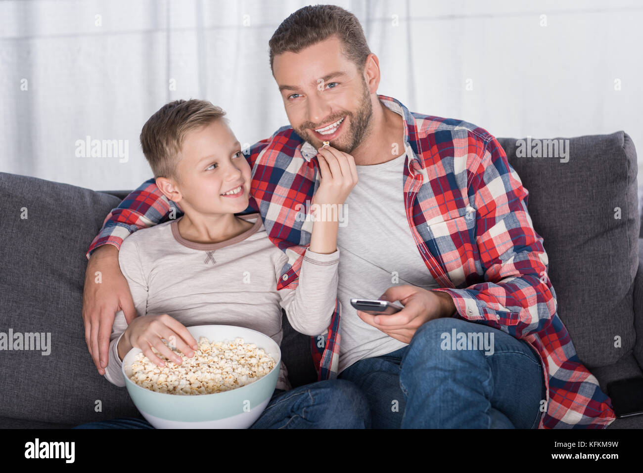 father and son watching tv Stock Photo - Alamy