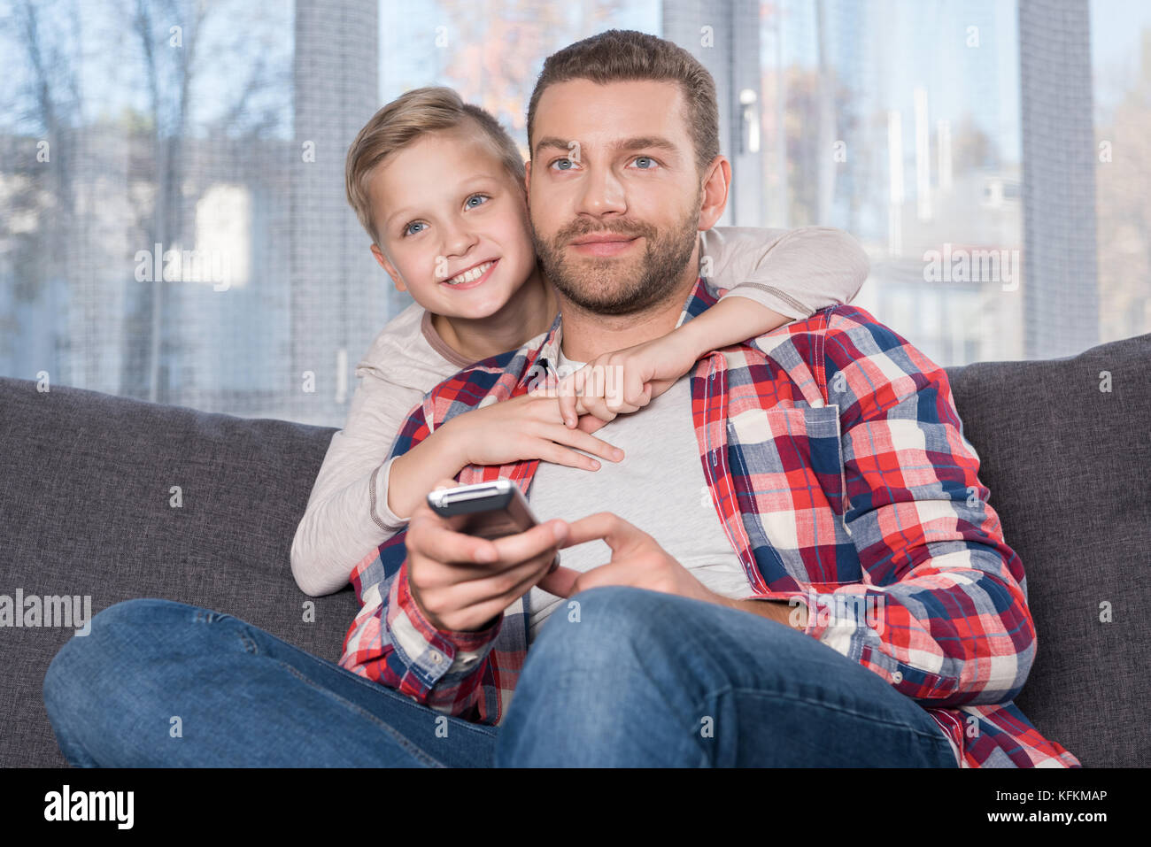 father and son watching tv Stock Photo - Alamy