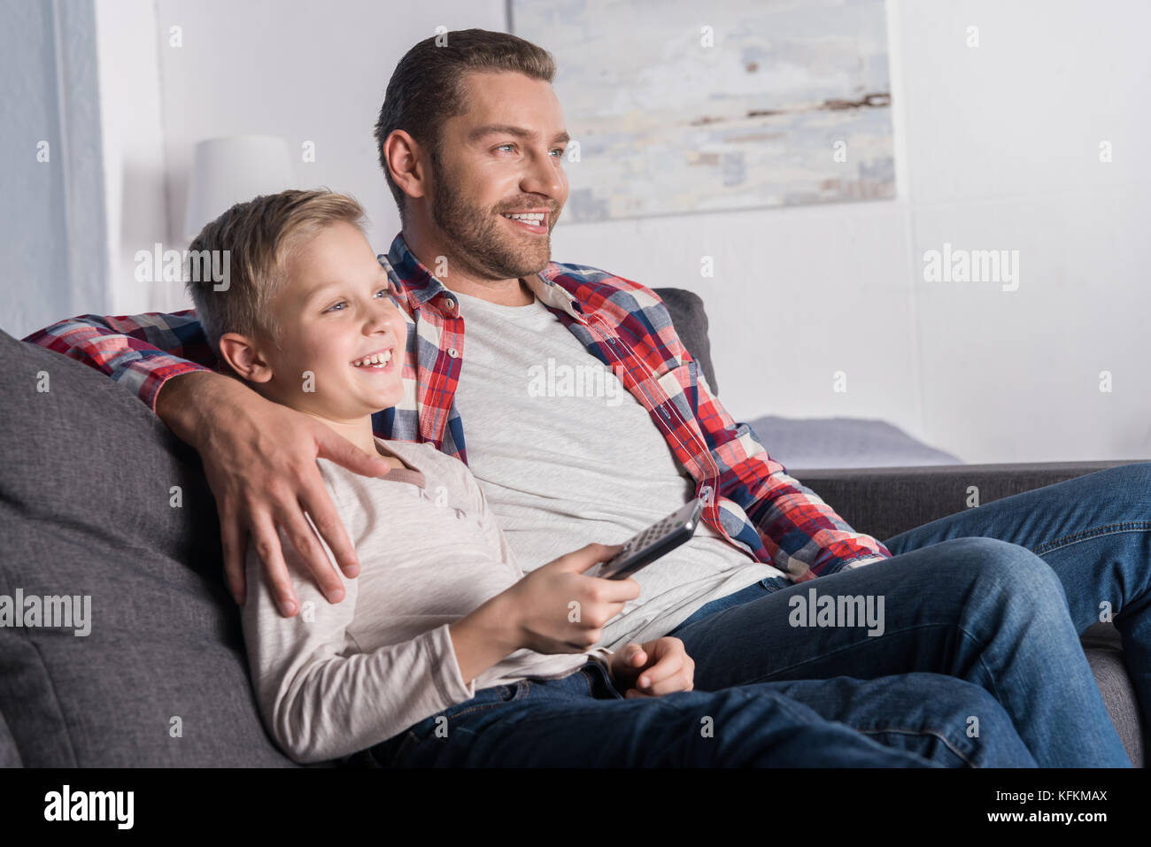 father and son watching tv Stock Photo - Alamy