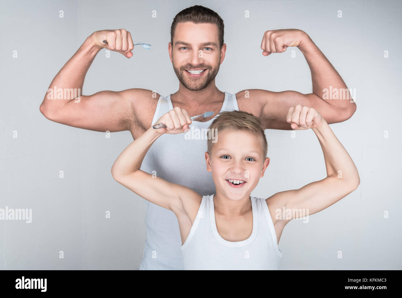 father and son showing biceps Stock Photo - Alamy
