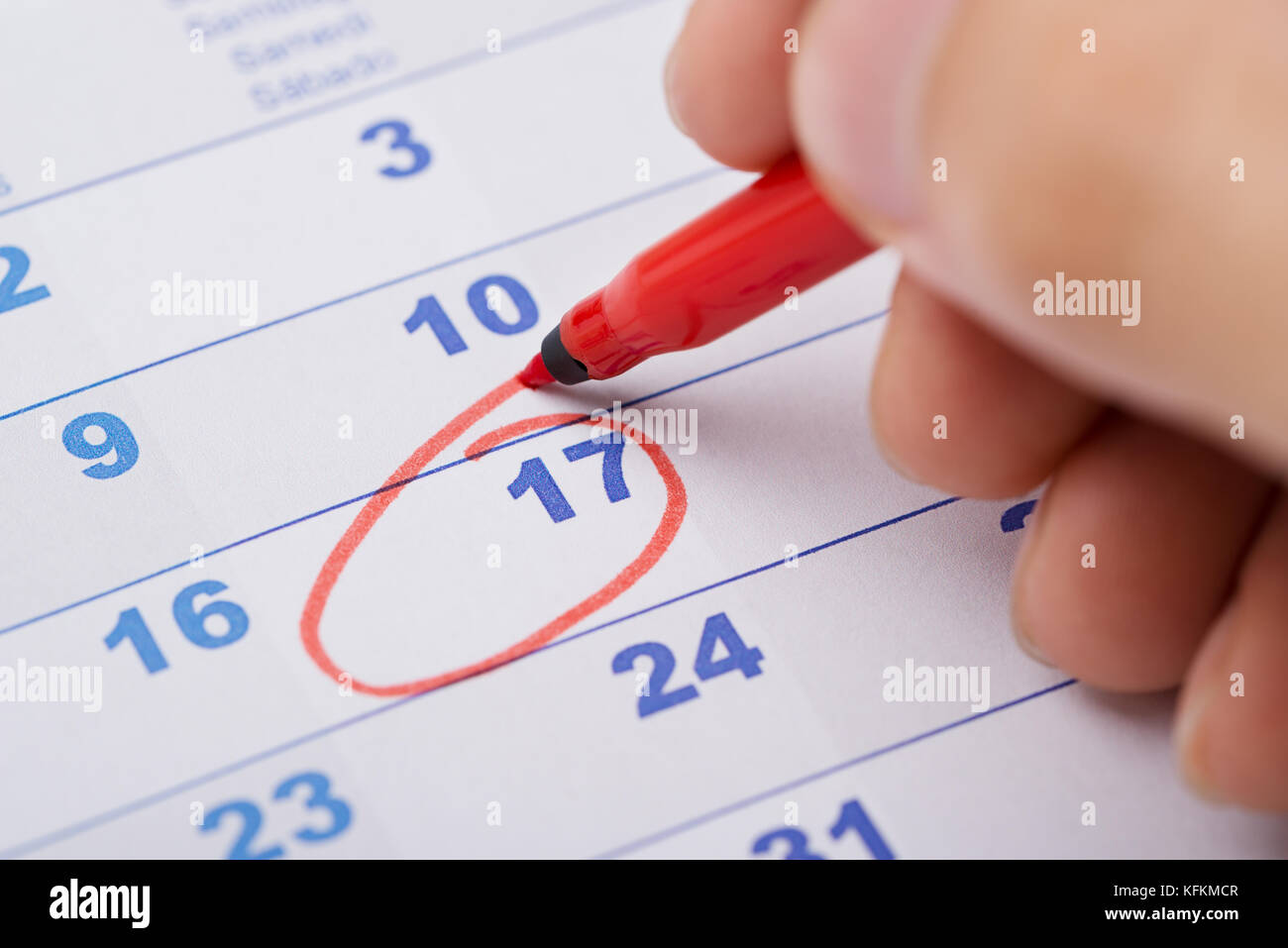 Cropped image of hand marking 17th date on calendar Stock Photo - Alamy
