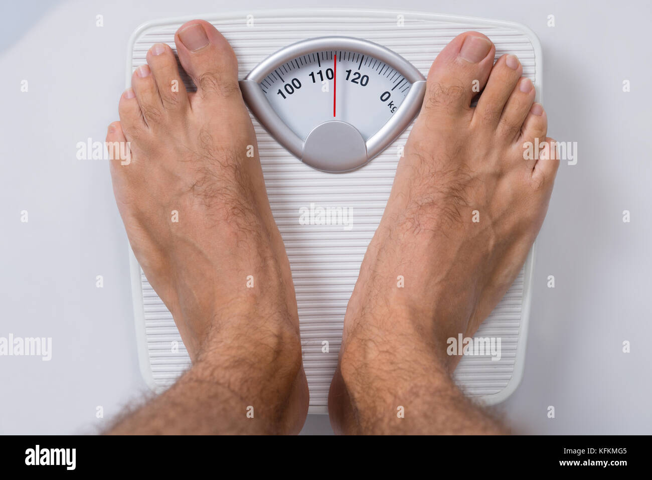 Overweight man standing on scale hi-res stock photography and images ...