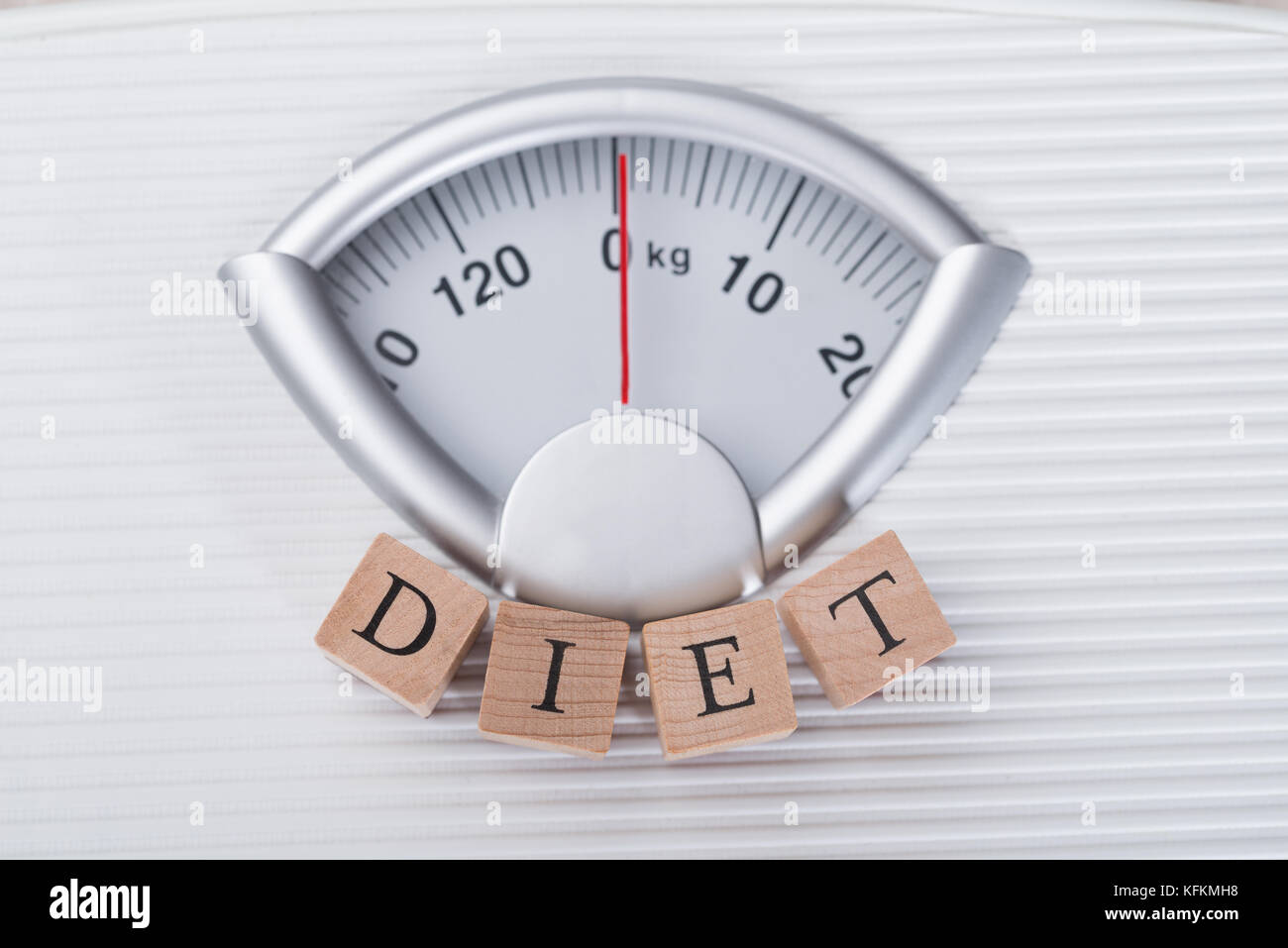 Closeup of Diet wooden blocks arranged on weighing scale Stock Photo ...