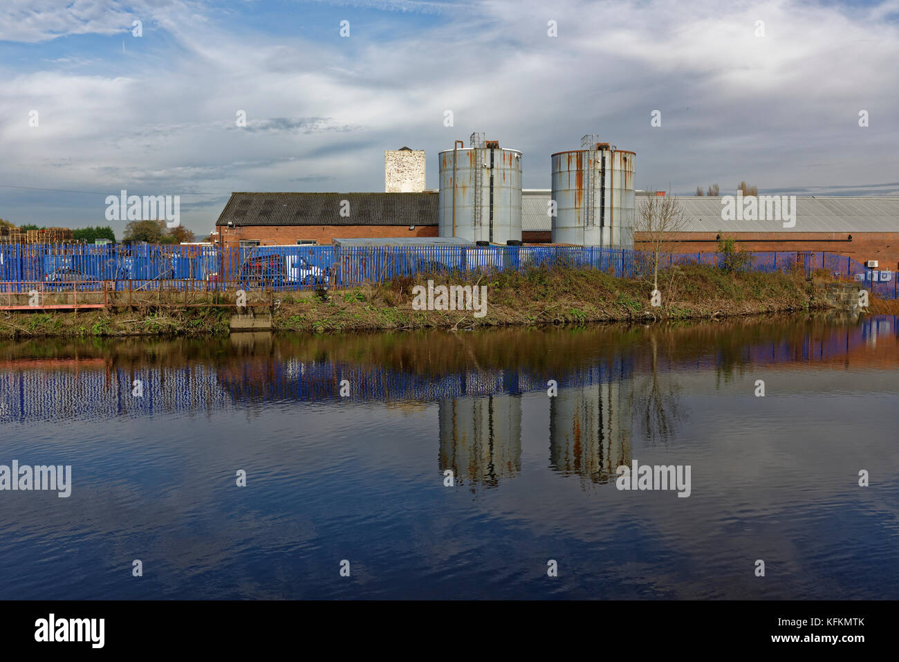 Riverside industry, two silos reflected in river irwell at radcliffe in ...