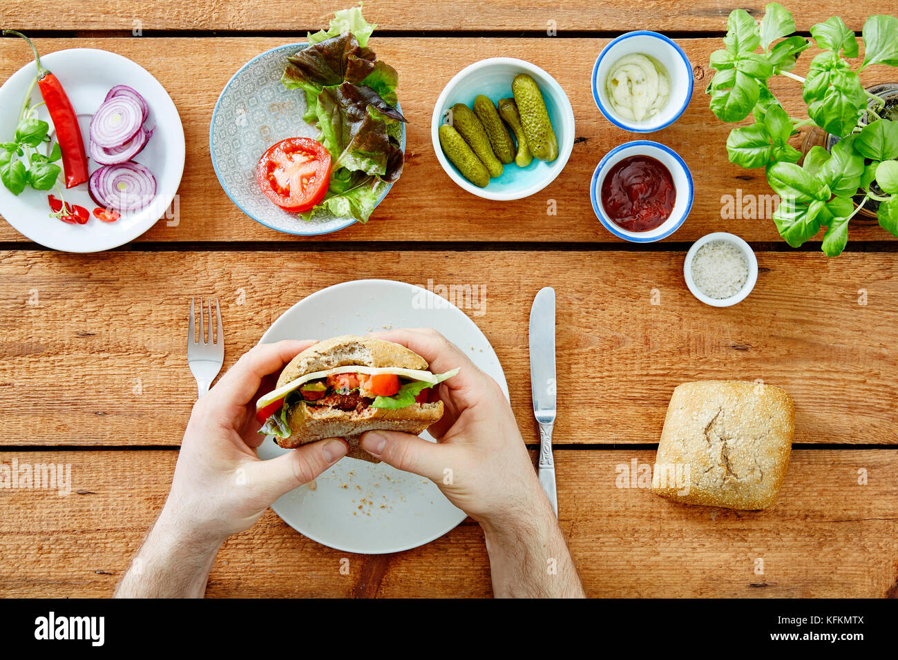 person taking first bite out of foodie snack Stock Photo - Alamy