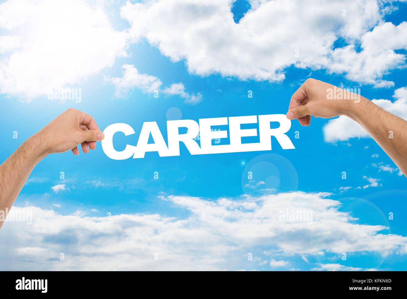 Cropped image of man's hands holding CAREER word against cloudy blue ...
