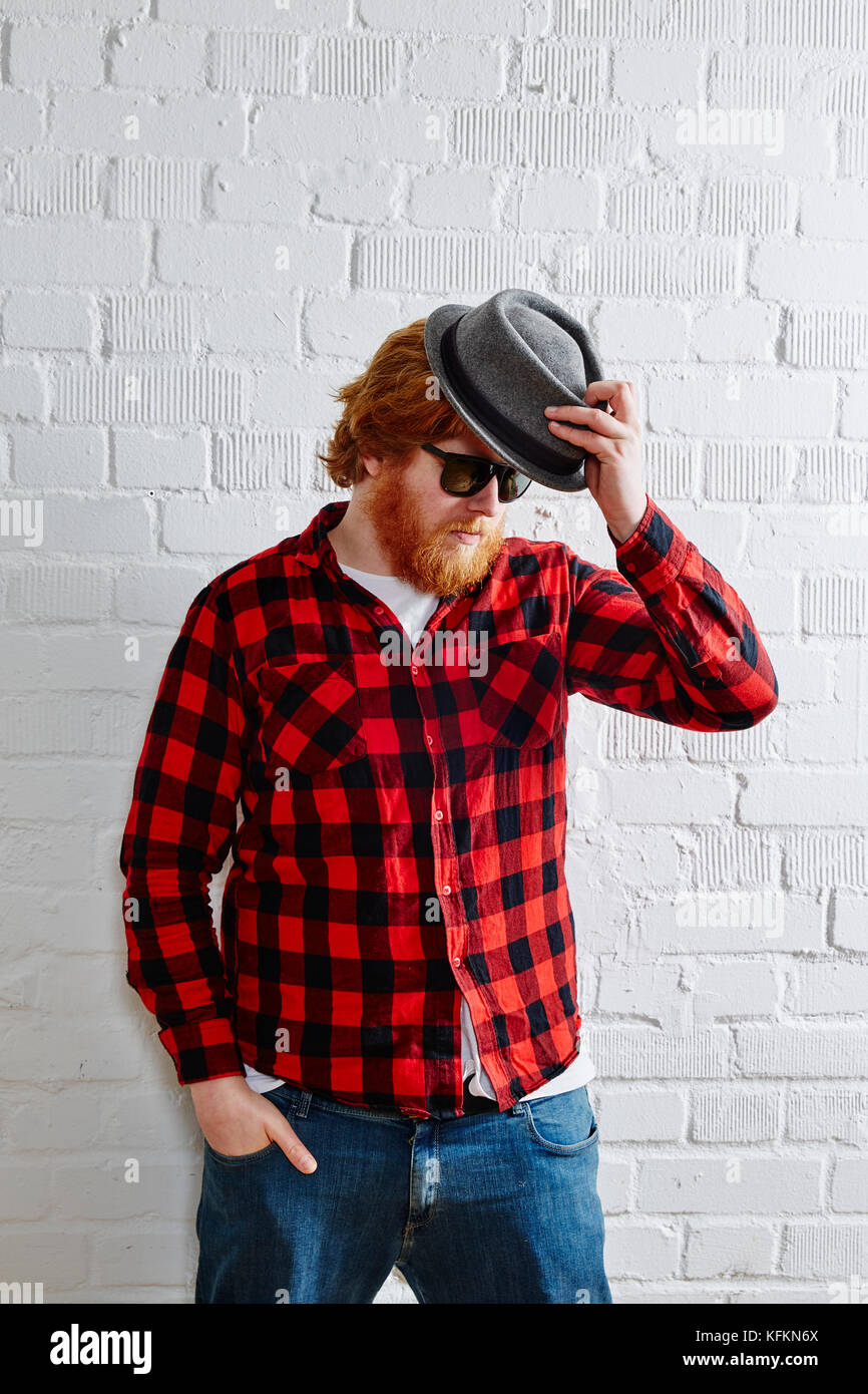 average ginger guy taking his hat casual look Stock Photo - Alamy