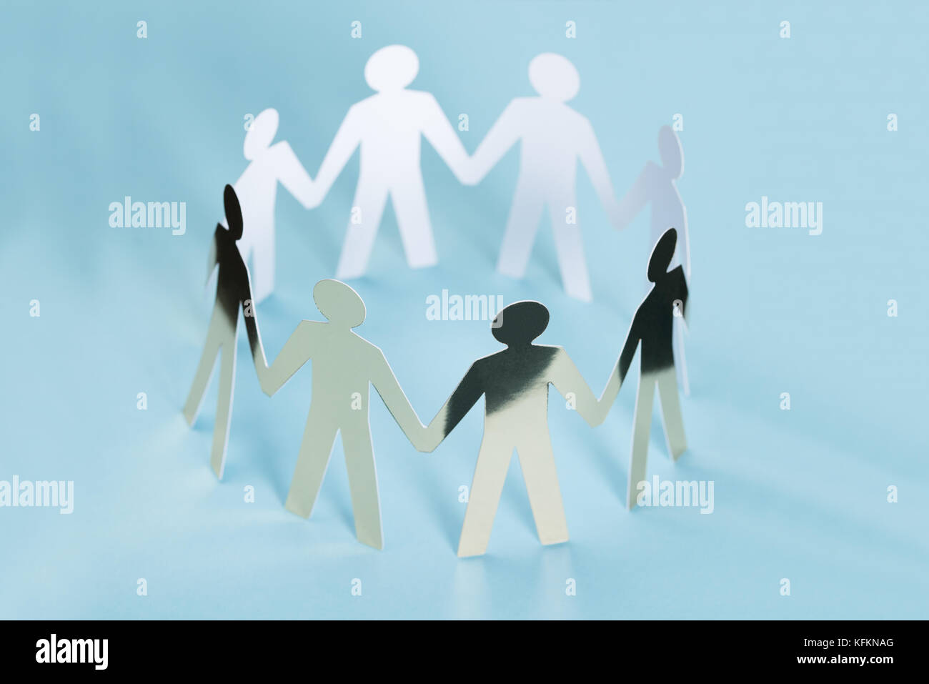 Closeup of metal team representing unity isolated over blue background ...