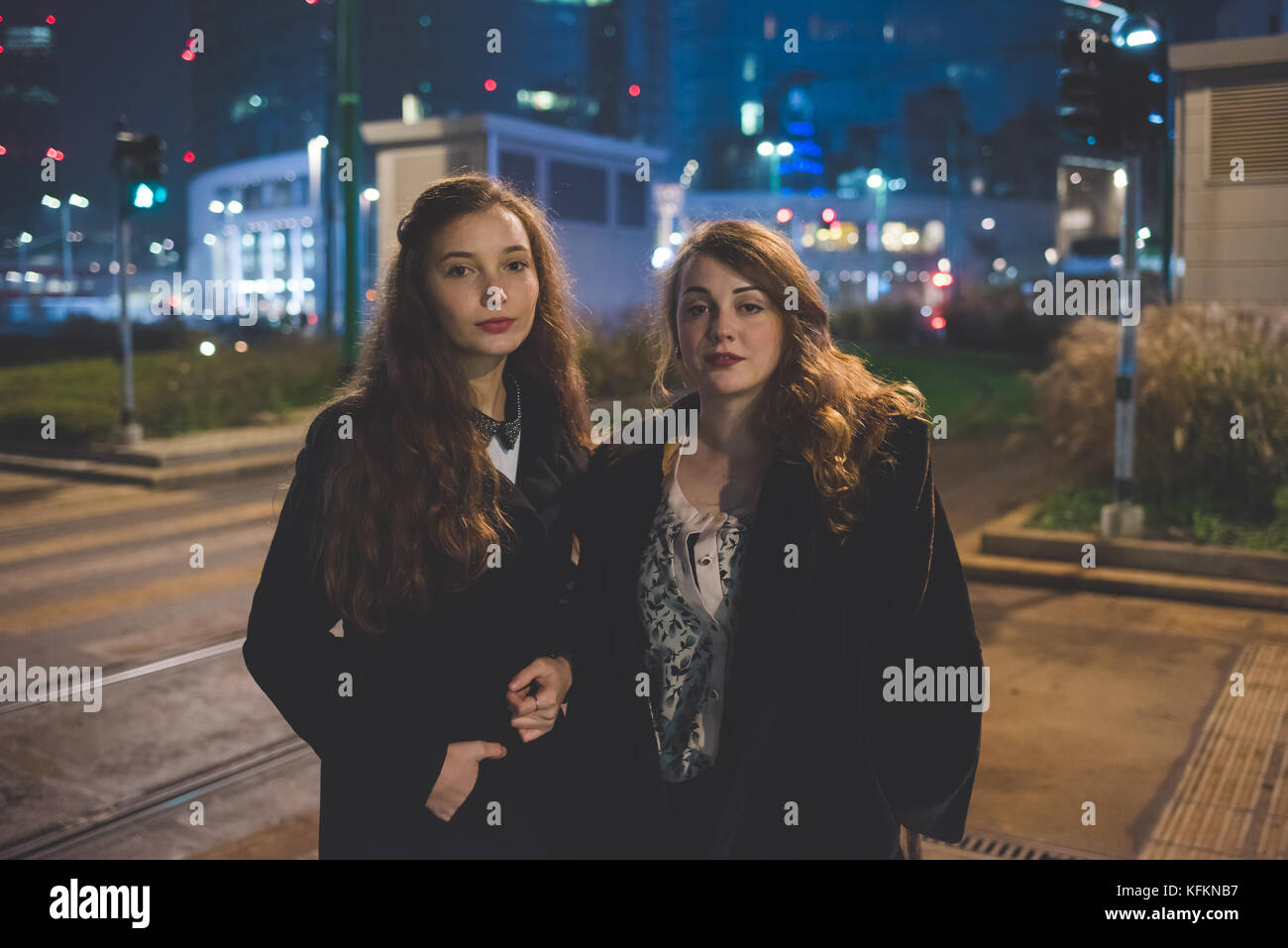 two young women beautiful outdoor posing looking camera - freindship ...