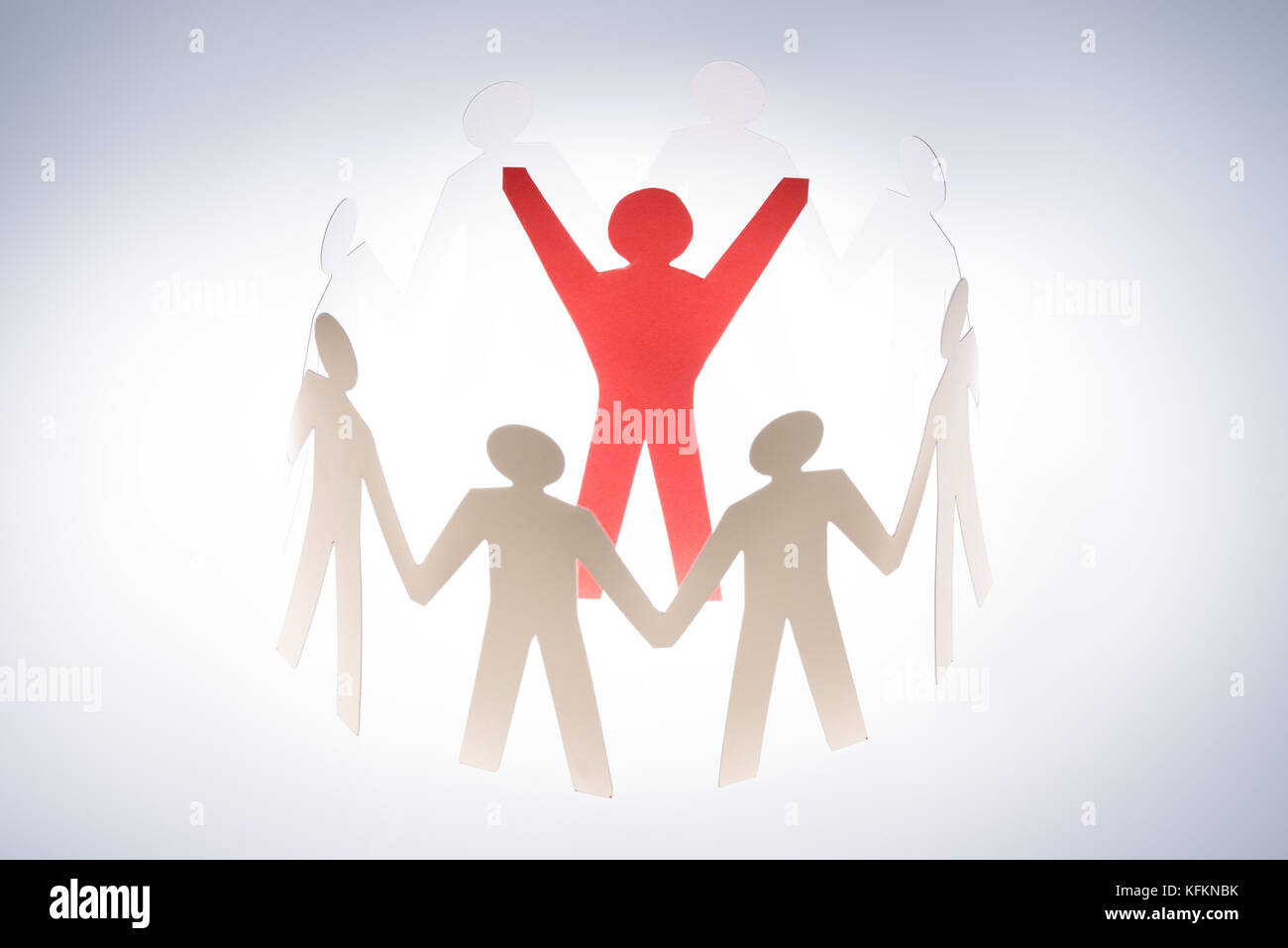 Successful red paperman surrounded by team representing unity isolated ...