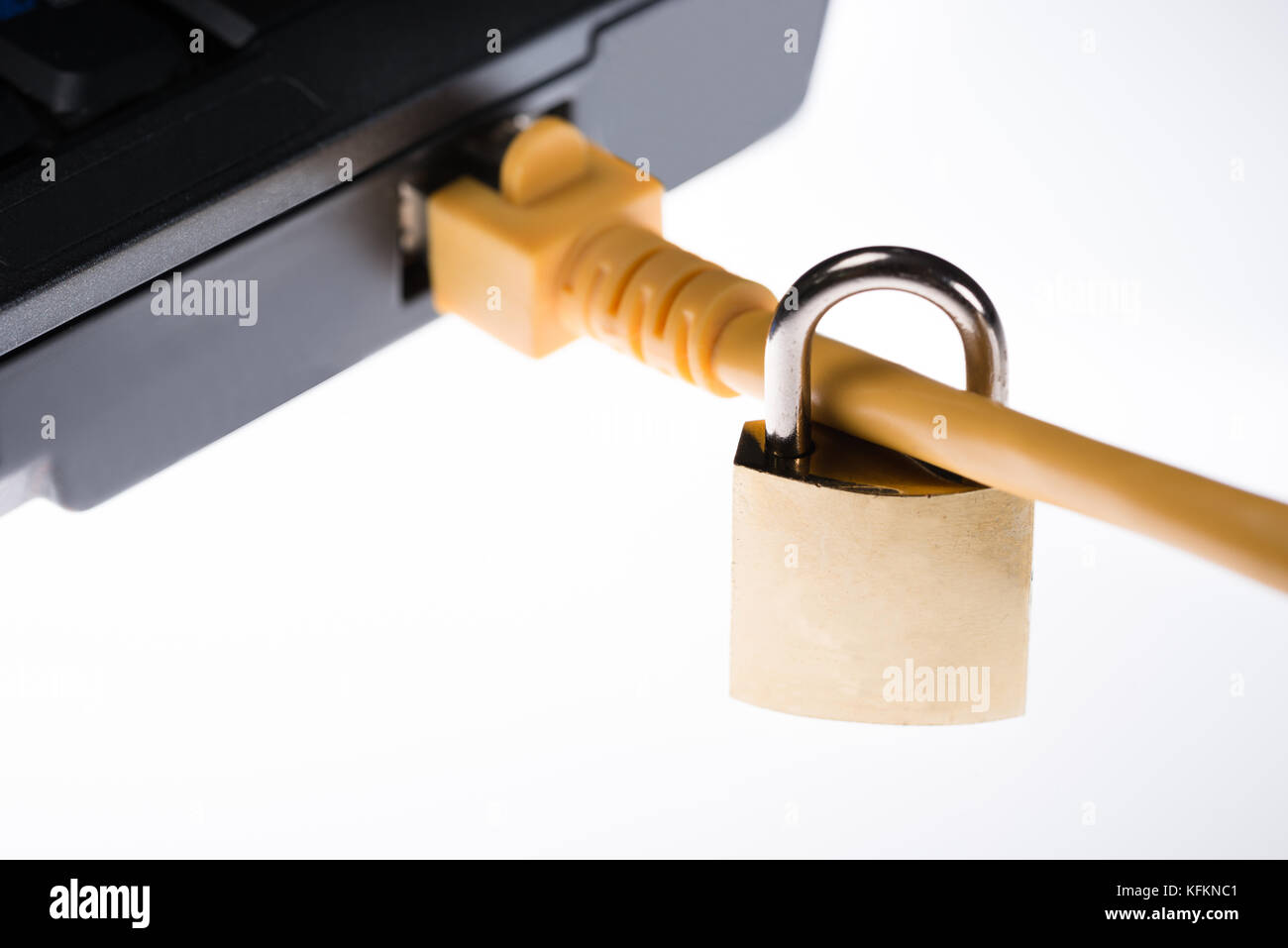 Closeup of padlock attached to plug in laptop isolated over white ...