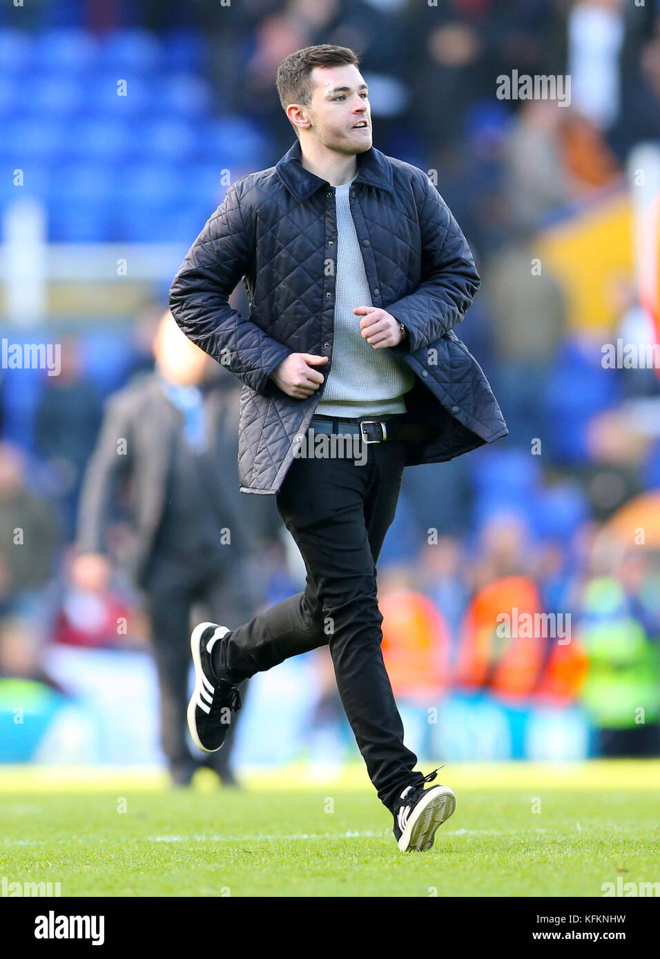 A pitch invader runs across the pitch Stock Photo - Alamy