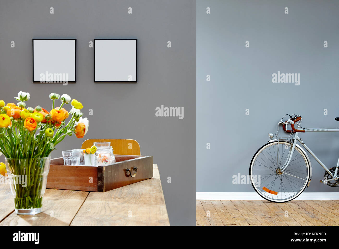flowers and decorated wooden table in vintage hipster cafe with bike ...