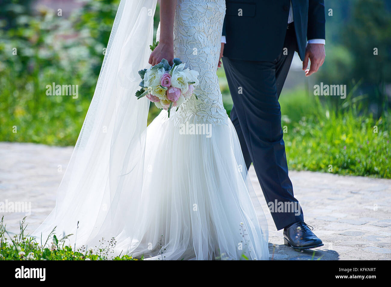 Cropped shot of Caucasian bride and groom walking together Stock Photo ...