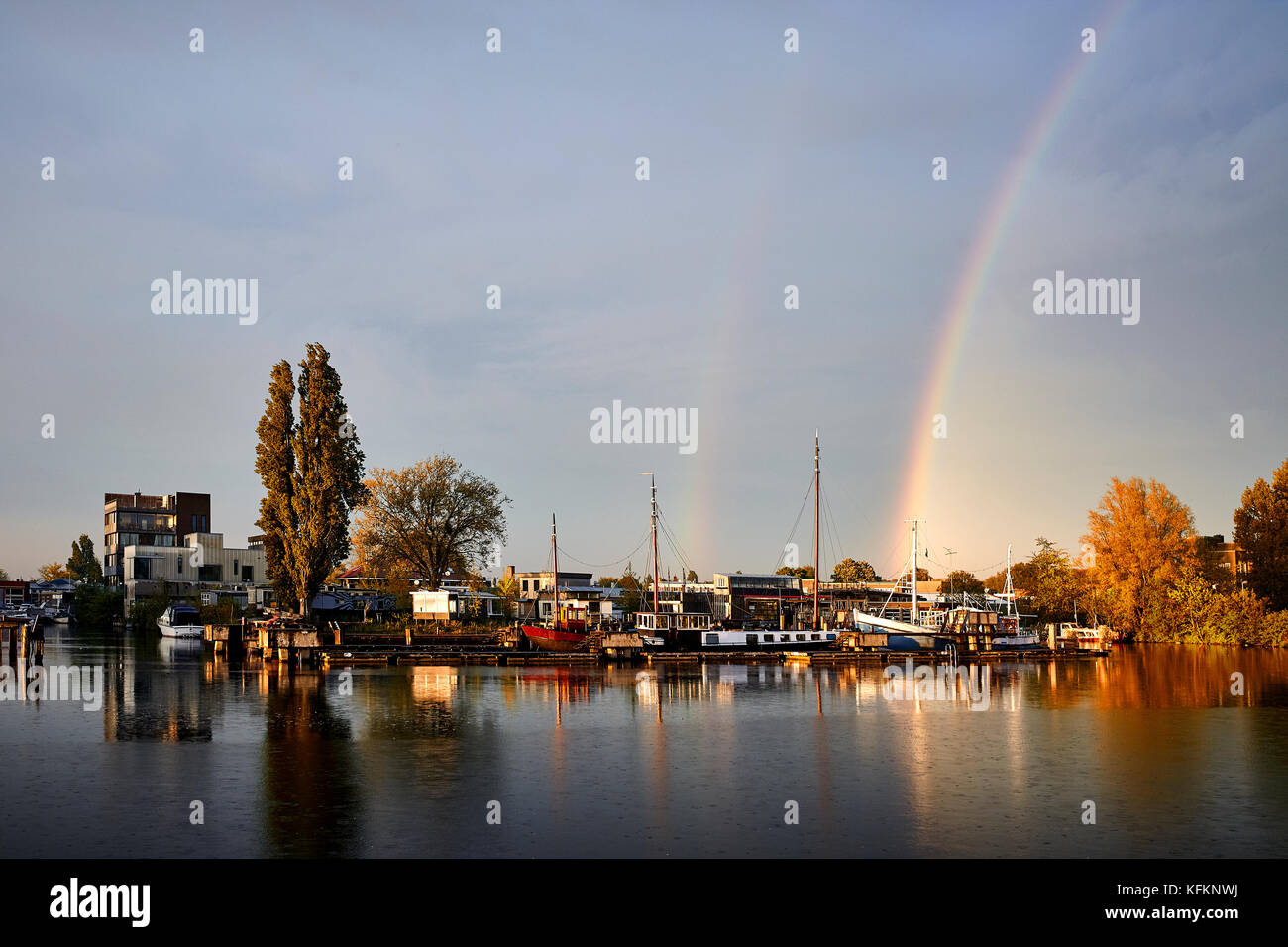 rainbow over channel in amsterdam netherlands Stock Photo - Alamy