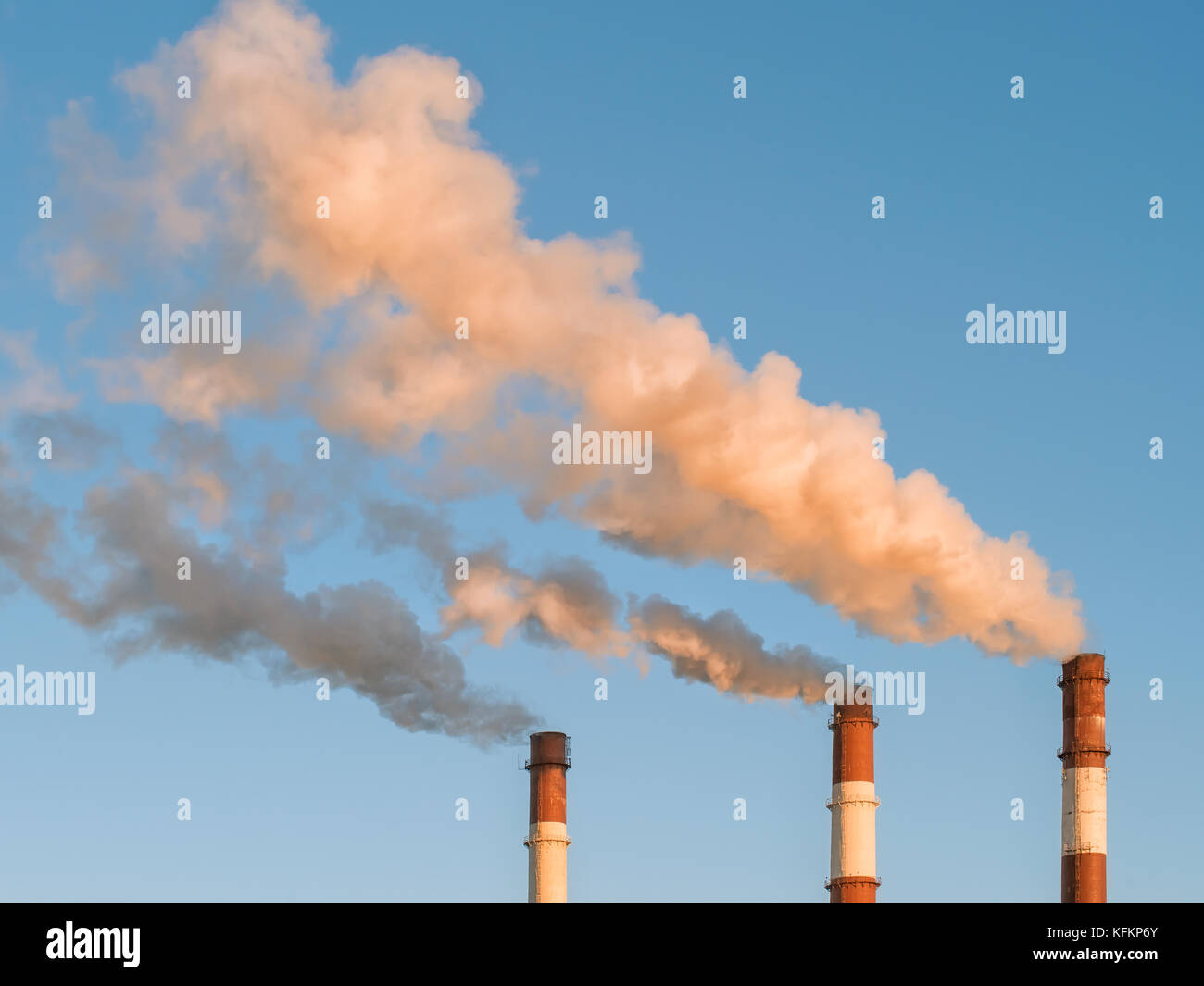 Factory chimneys with thick smoke. Industrial production and pollution ...