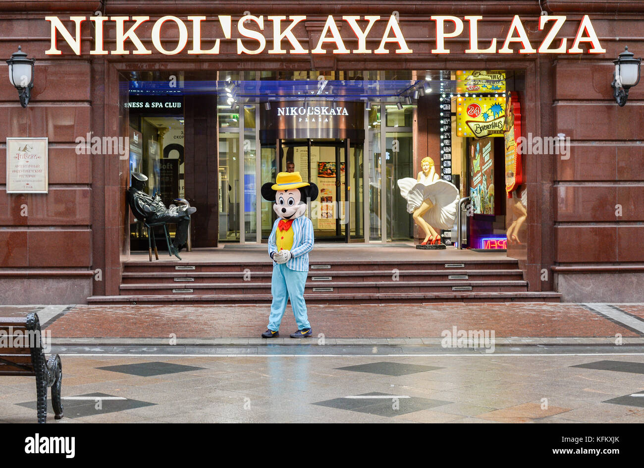 A person dressed as Mickey Mouse stands in front of the Nikolskaya ...